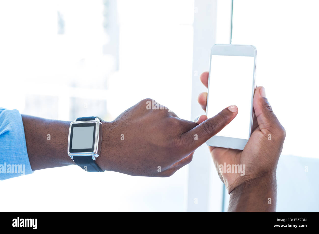 Hand using mobile phone at home Stock Photo - Alamy
