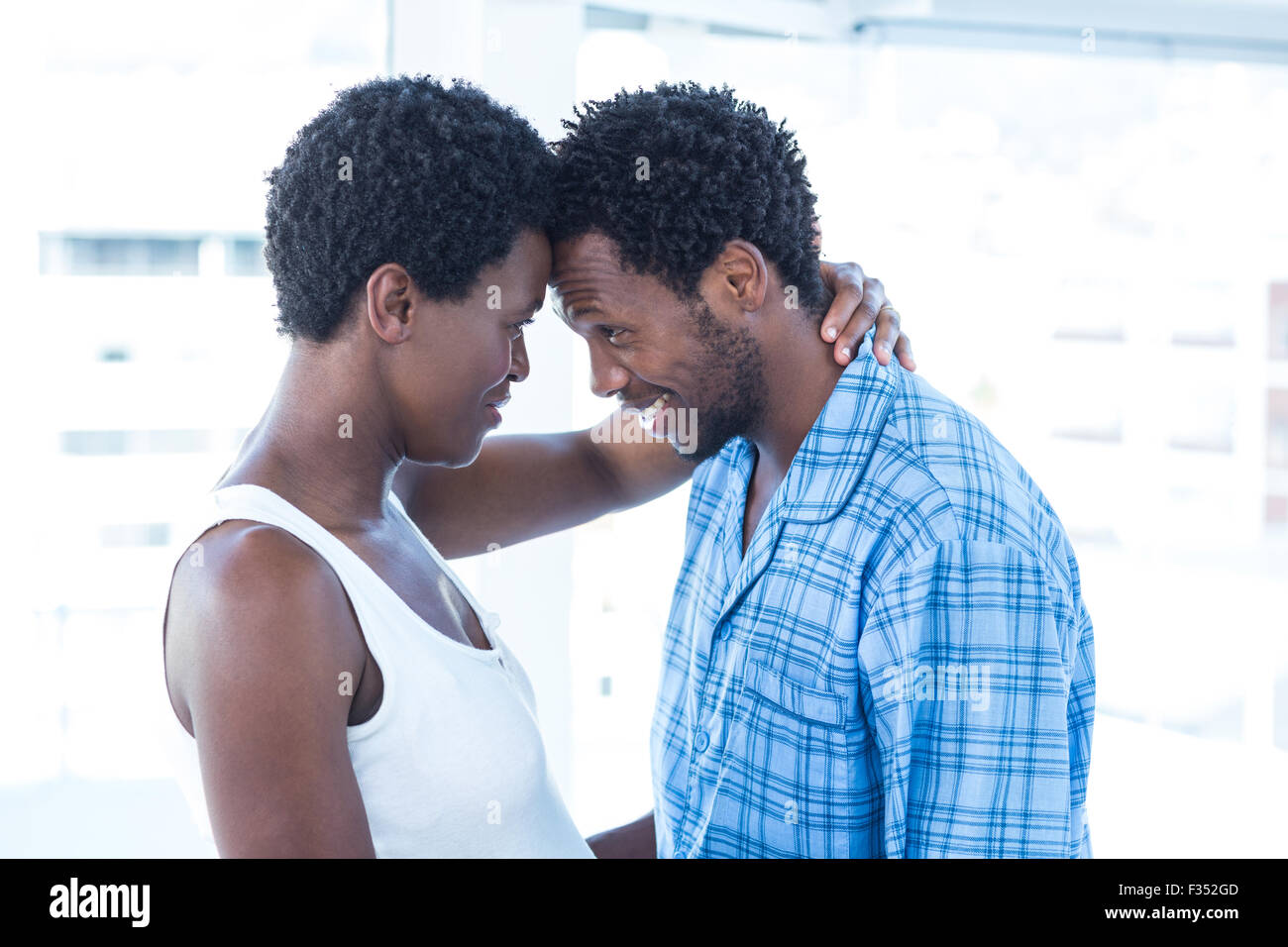 Couple touching heads while standing Stock Photo - Alamy