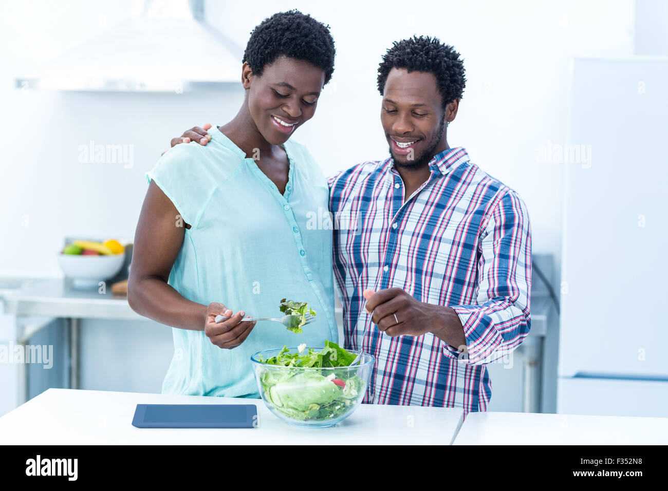 Couple having salad while standing Stock Photo - Alamy