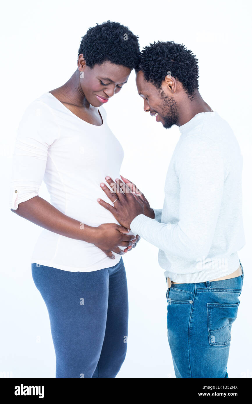 Cheerful Man Touching His Pregnant Wife Belly While Standing Stock