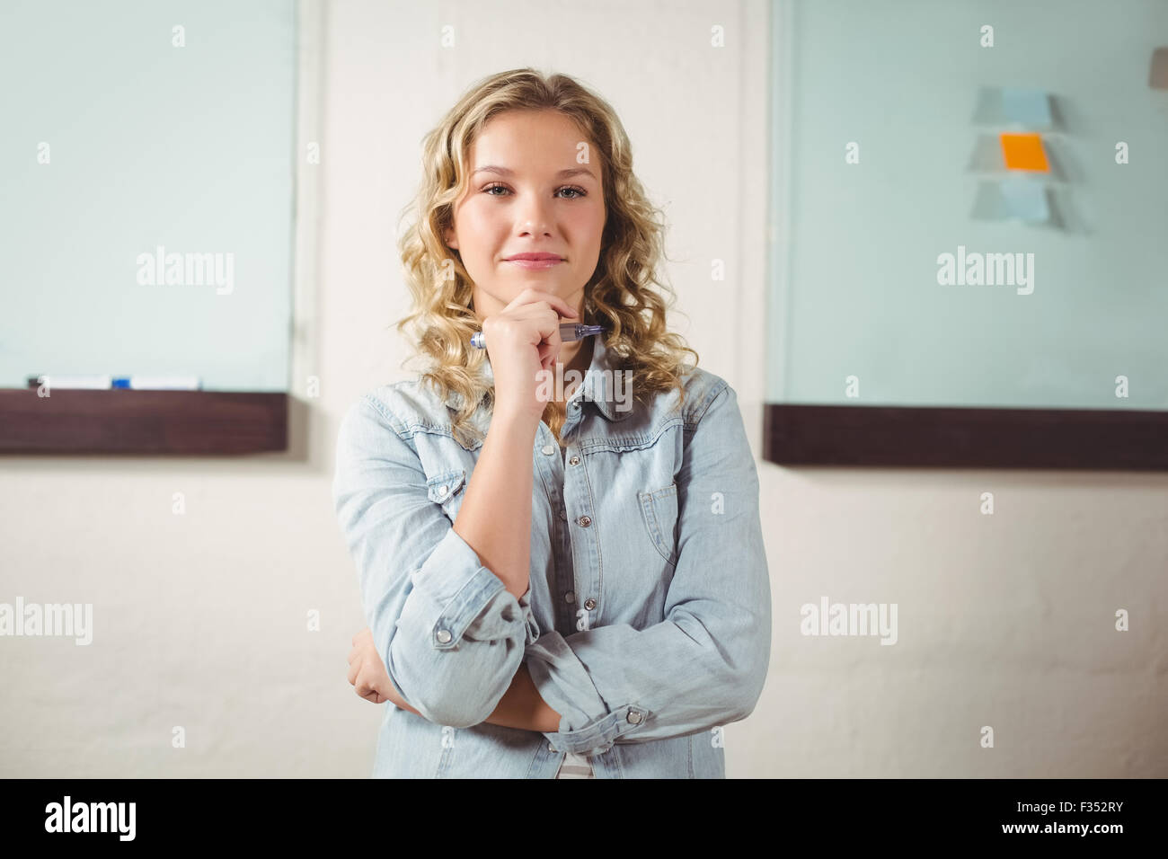 Portrait of beautiful confident woman standing in office Stock Photo ...