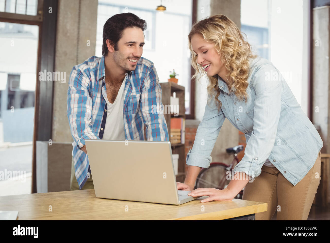 Colleagues smiling at office Stock Photo - Alamy