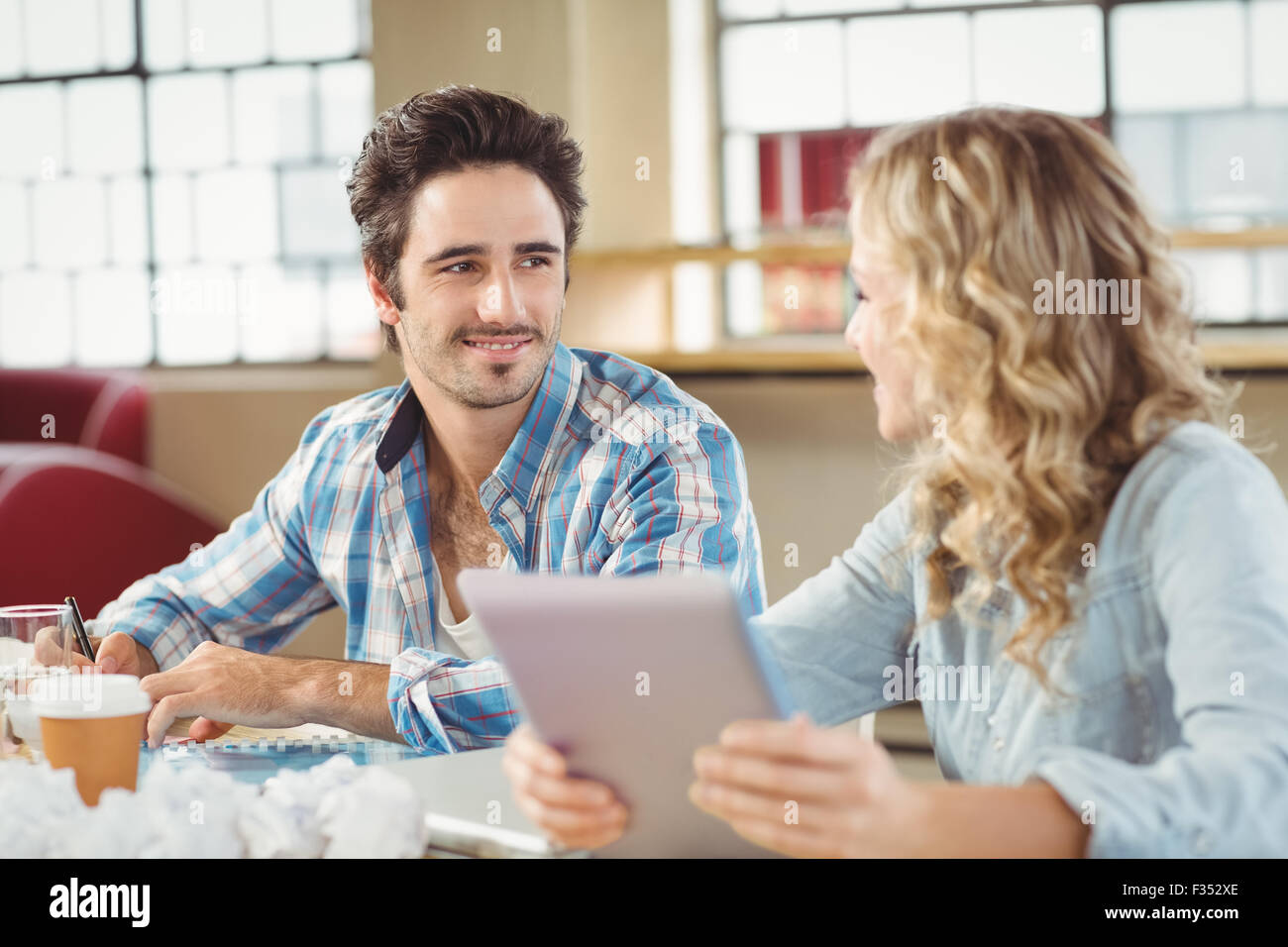 Colleagues talking about work Stock Photo - Alamy