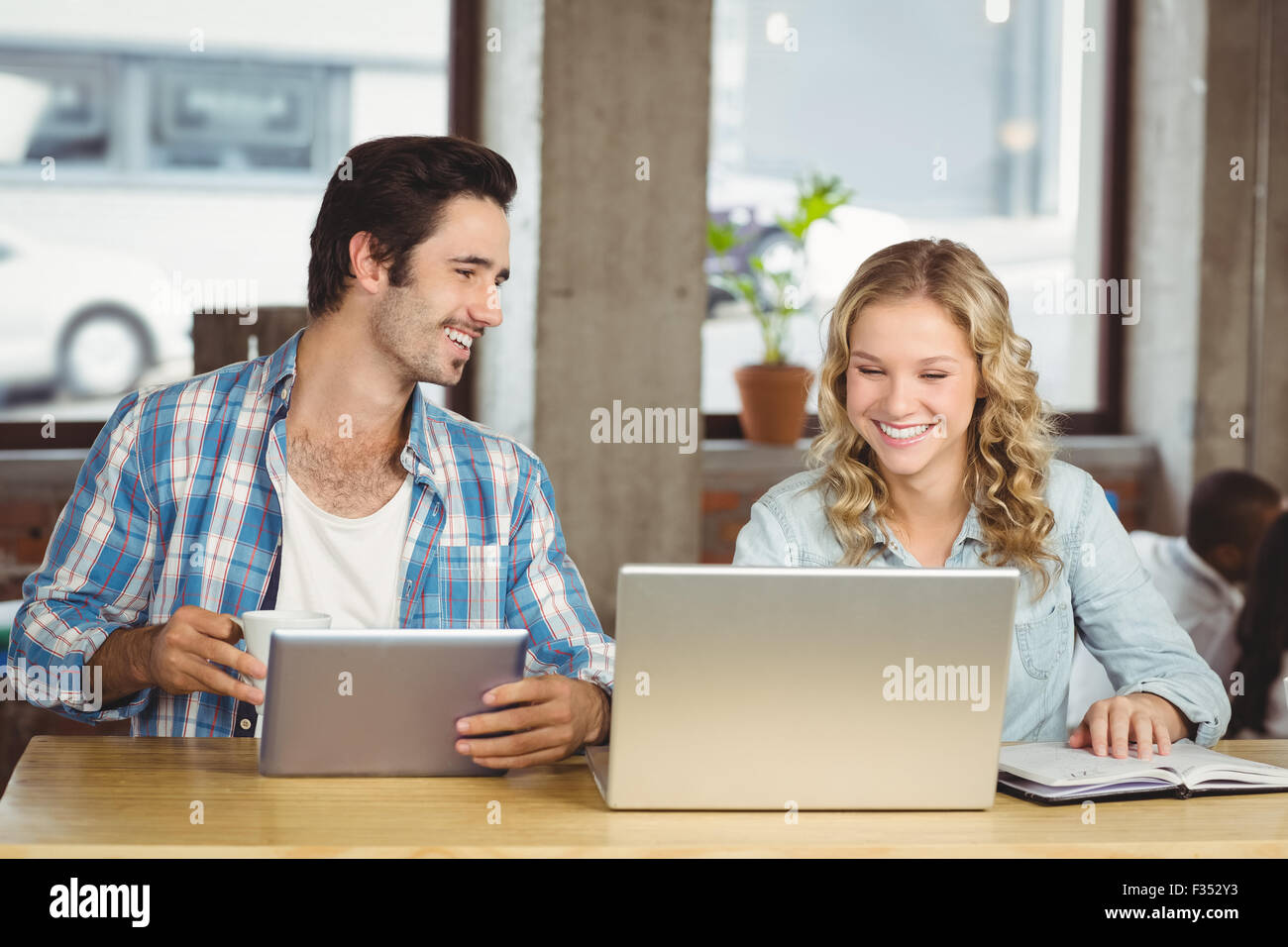 Young people smiling and working Stock Photo - Alamy