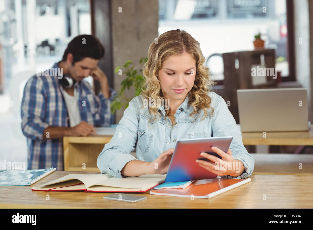 Beautiful businesswoman using table in office Stock Photo - Alamy