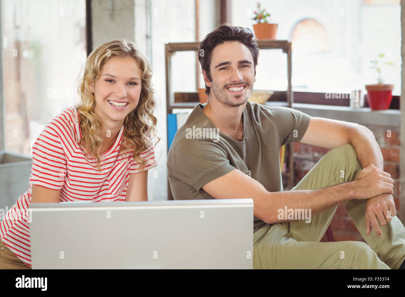 Portrait of happy business people using computer in office Stock Photo ...