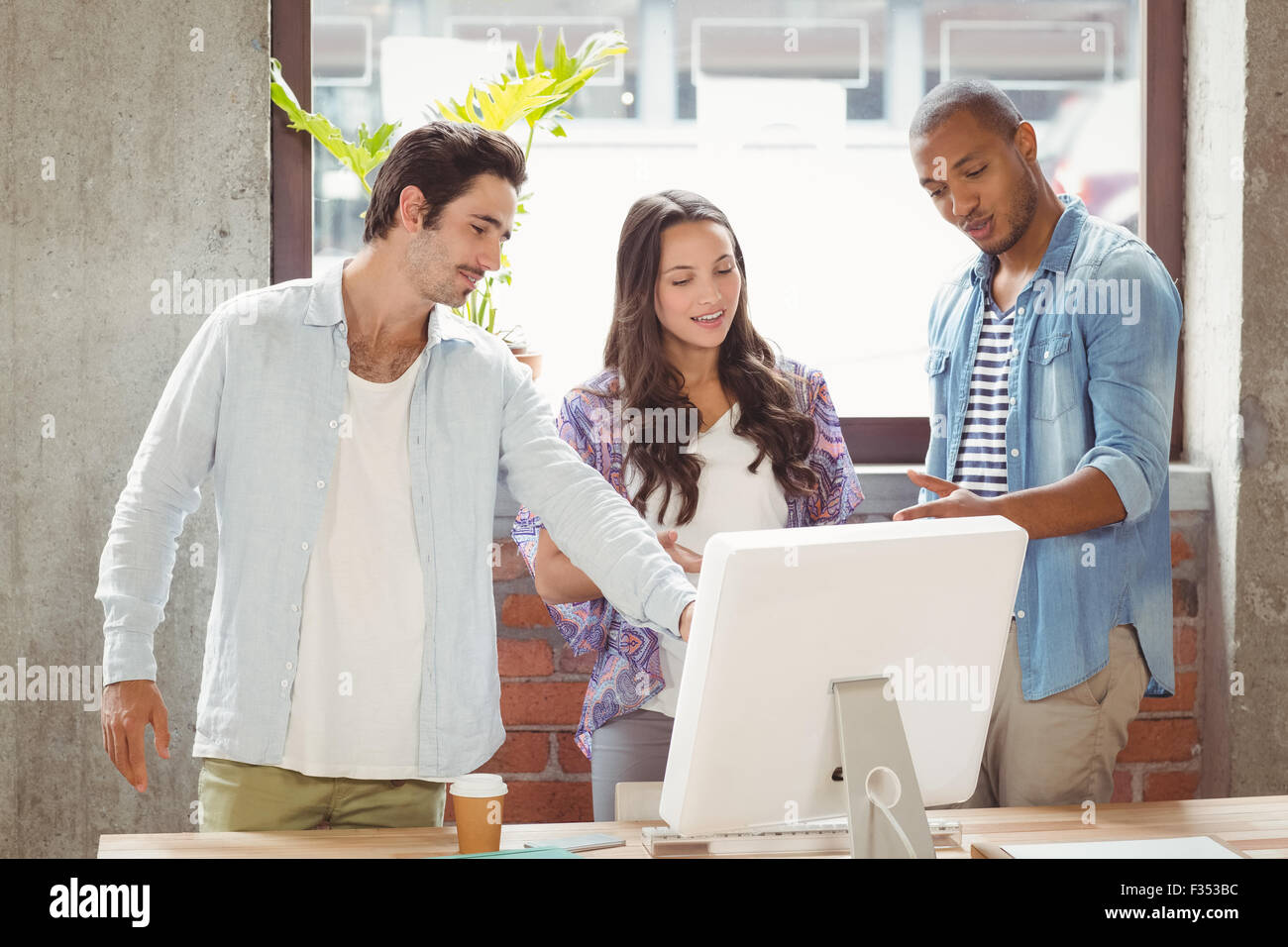 Business people pointing at monitor hi-res stock photography and images ...