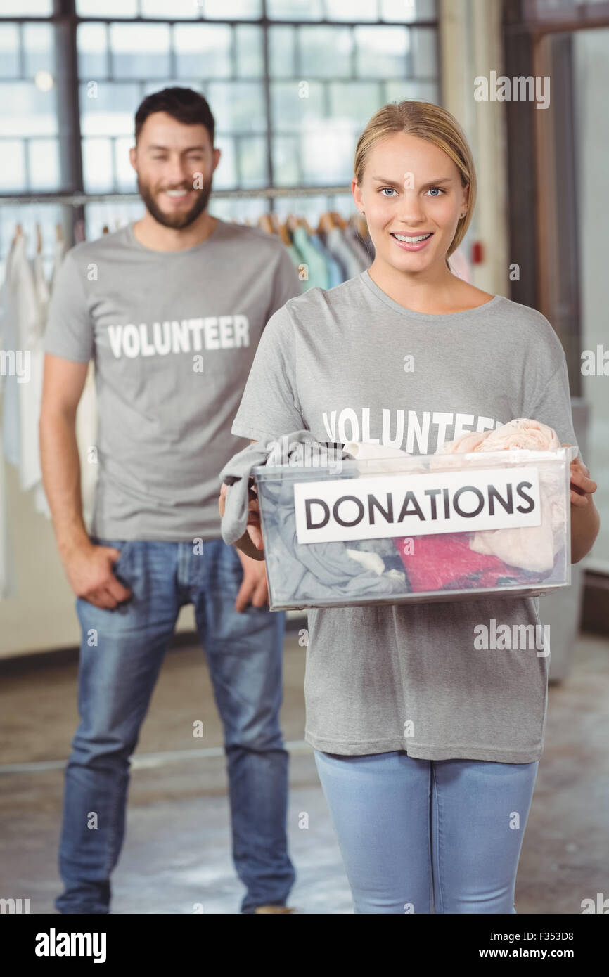 Volunteer holding clothes donation box Stock Photo - Alamy