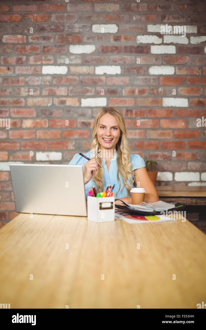 Portrait of woman working while sitting in office Stock Photo - Alamy