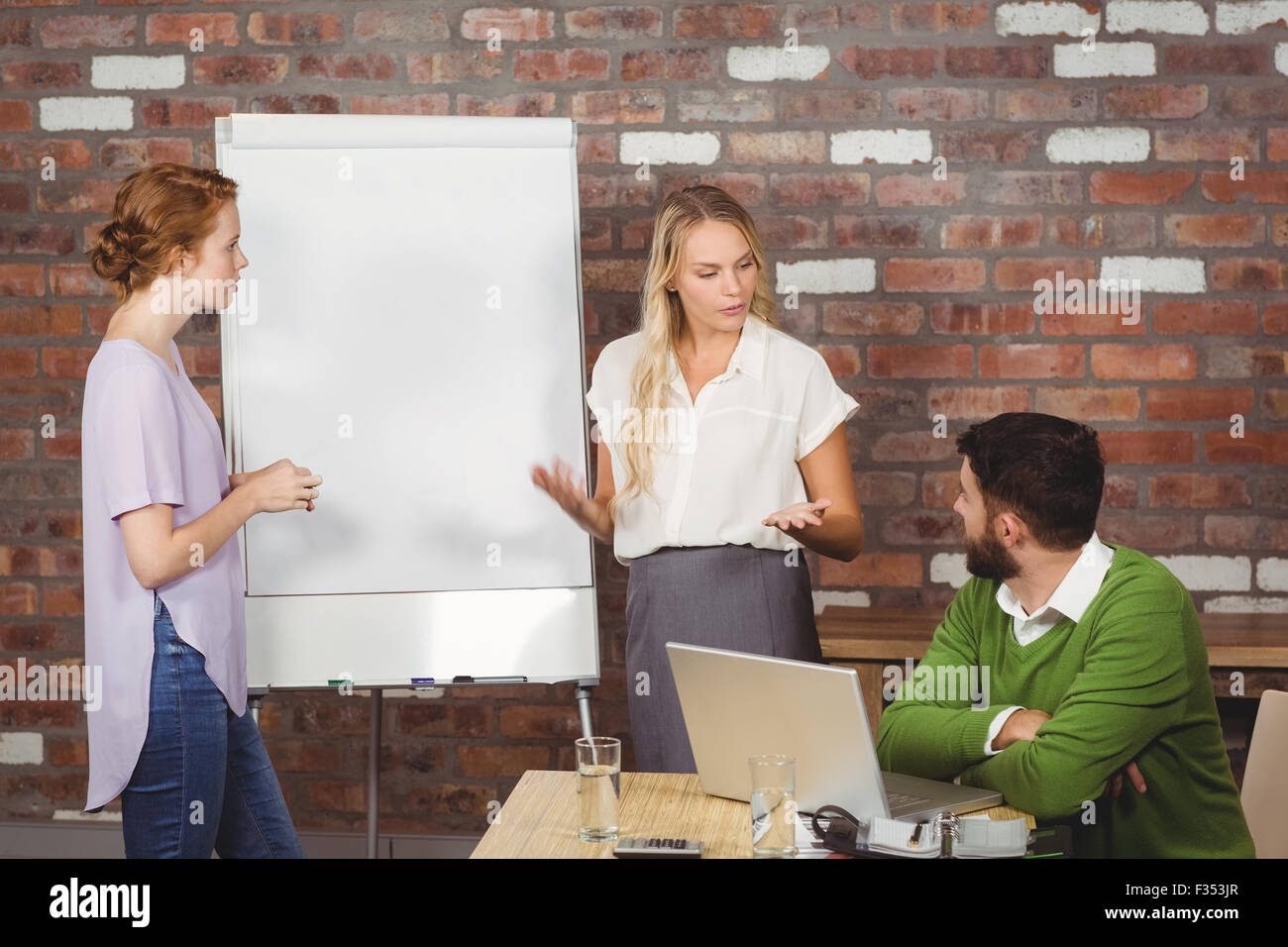Businesswoman briefing colleagues in office Stock Photo - Alamy
