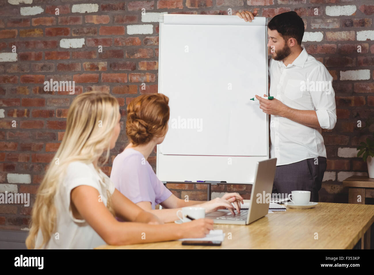 Businessman briefing over whiteboard to colleagues Stock Photo - Alamy