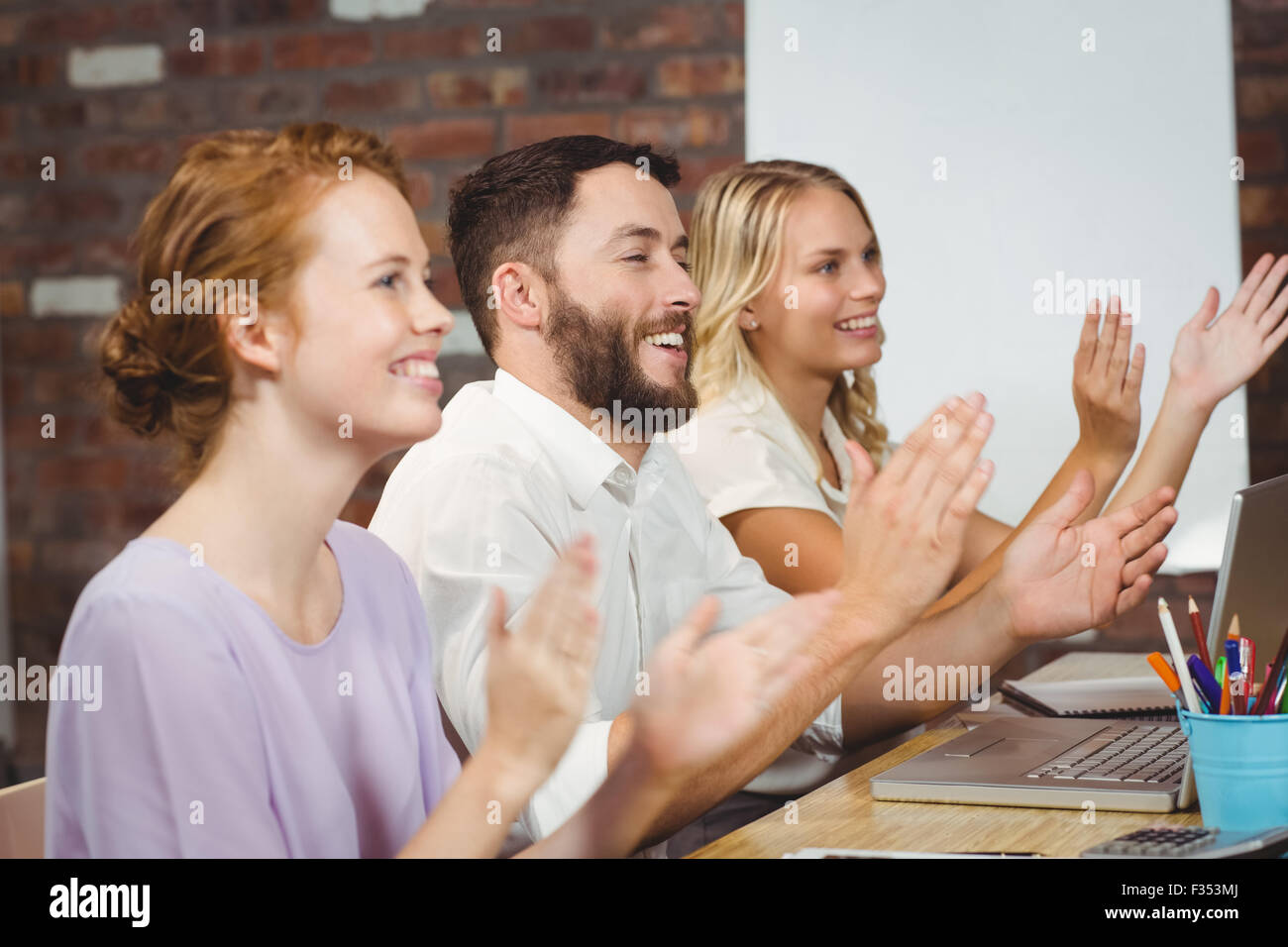 Happy colleagues clapping at meeting Stock Photo - Alamy