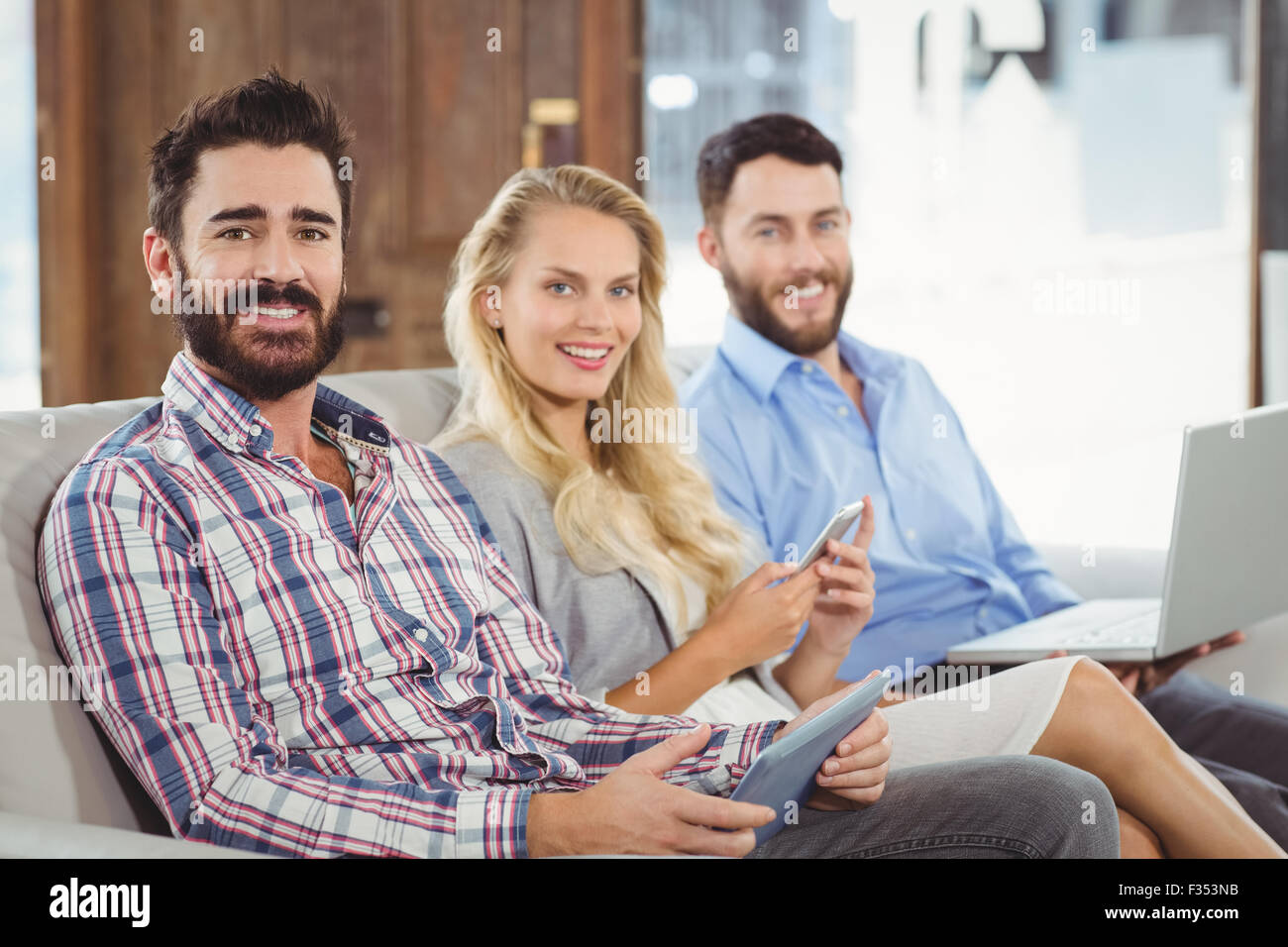 Portrait of smiling business people using technologies Stock Photo - Alamy