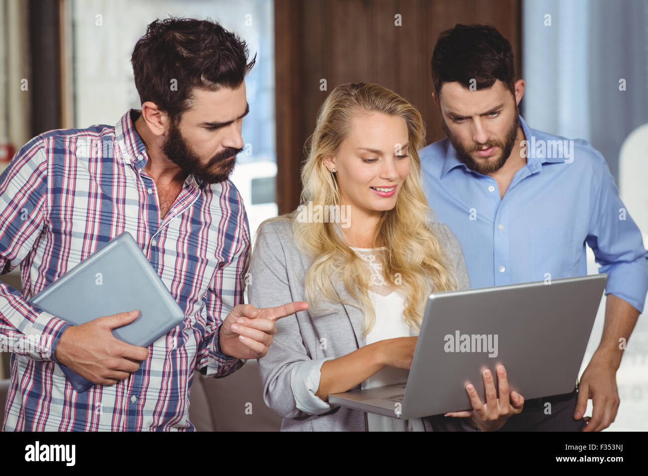 Man pointing towards laptop Stock Photo - Alamy