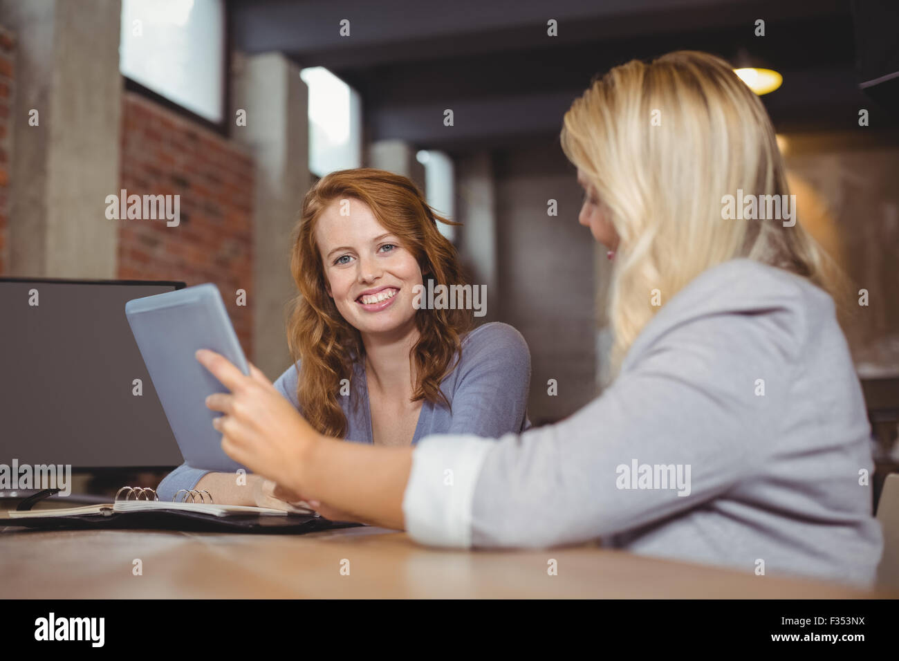 Portrait of smiling businesswomen during discussion Stock Photo - Alamy