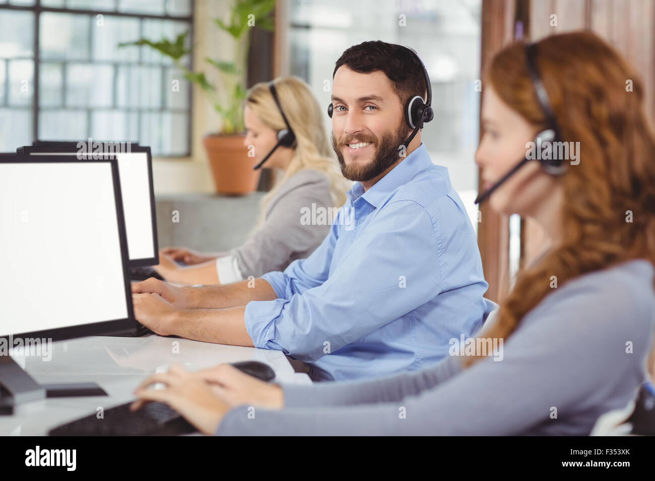 Portrait of smiling man working in office Stock Photo - Alamy