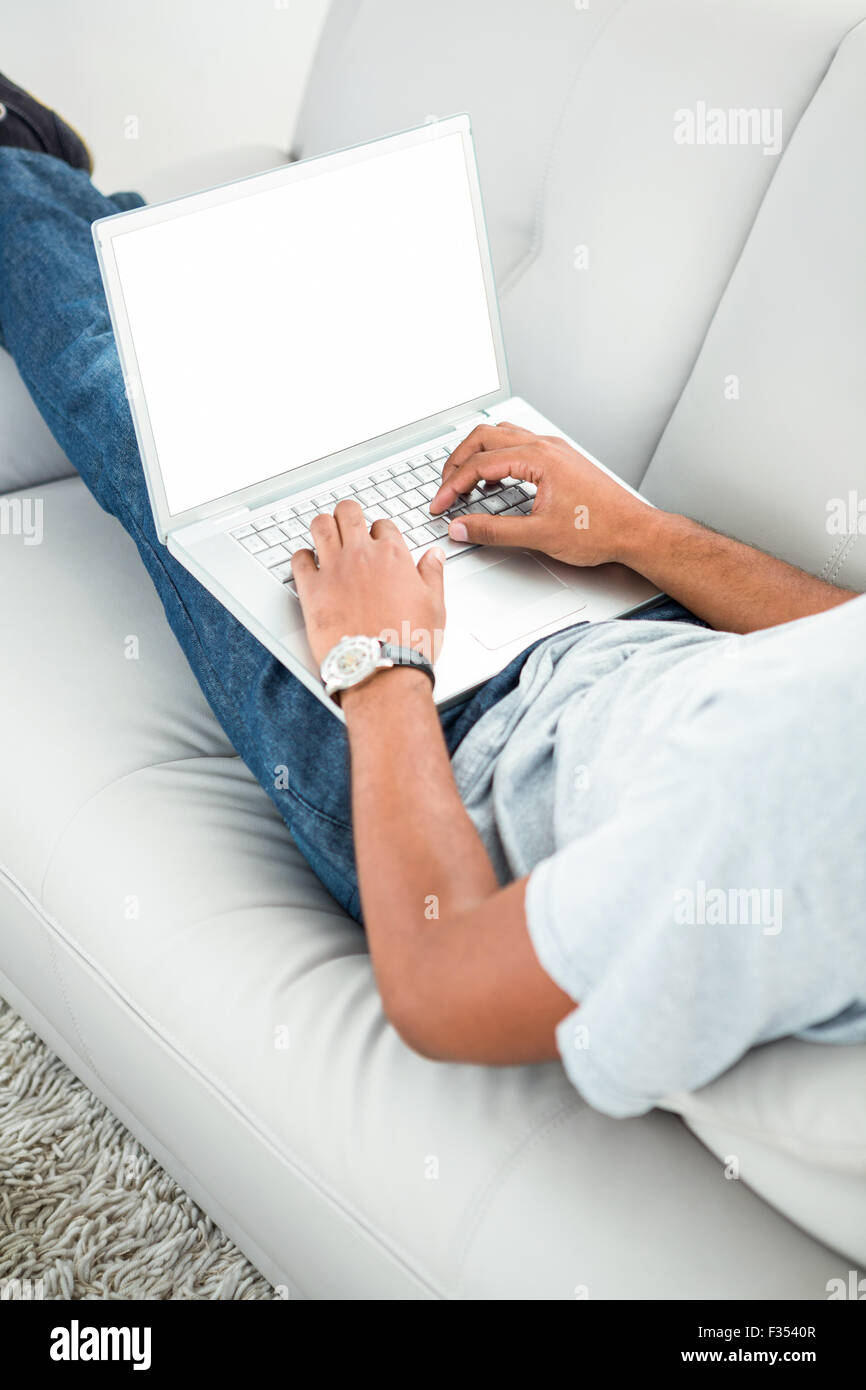 A man typing on his laptop Stock Photo - Alamy