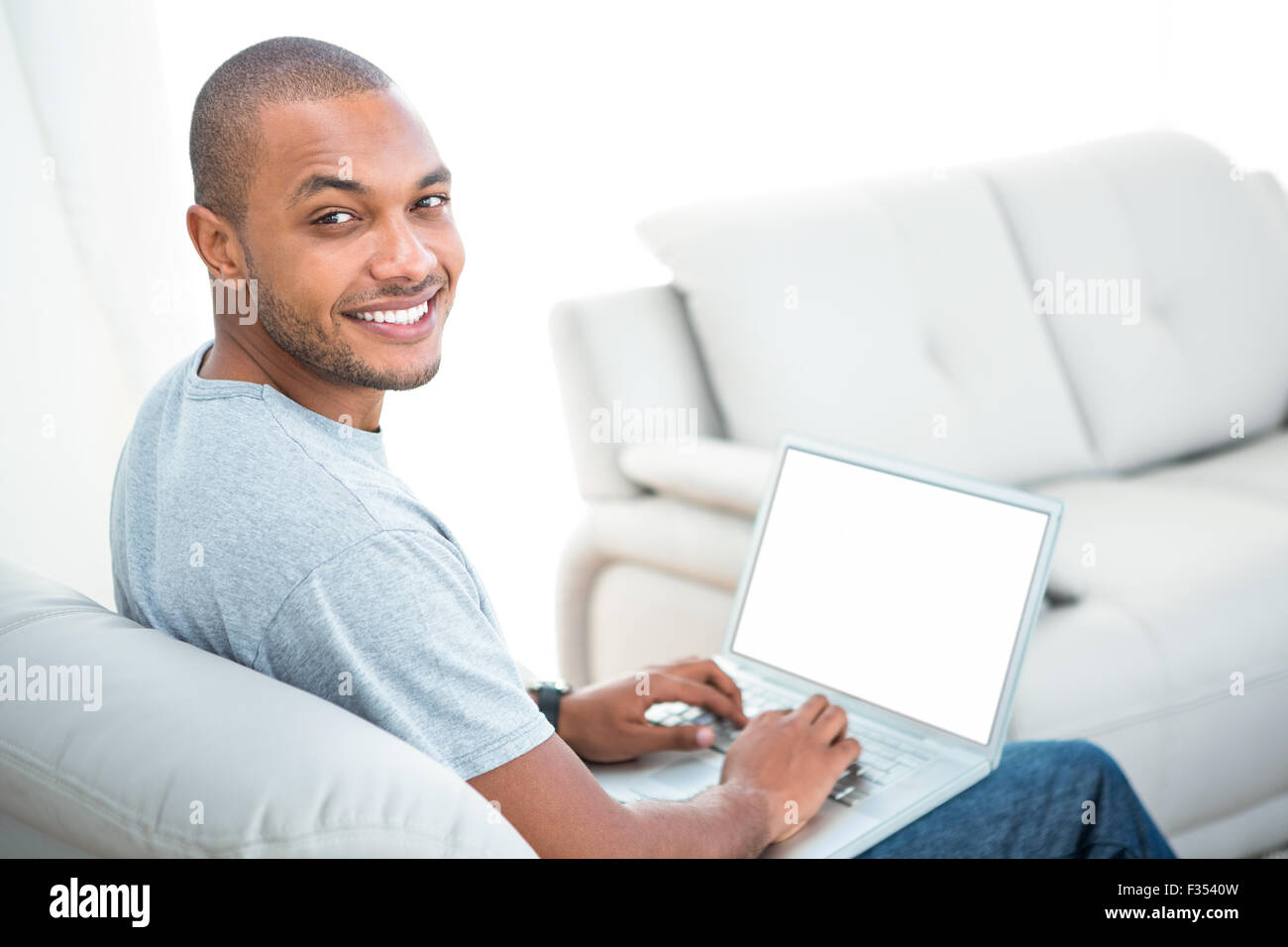 Portrait of happy man with laptop Stock Photo - Alamy