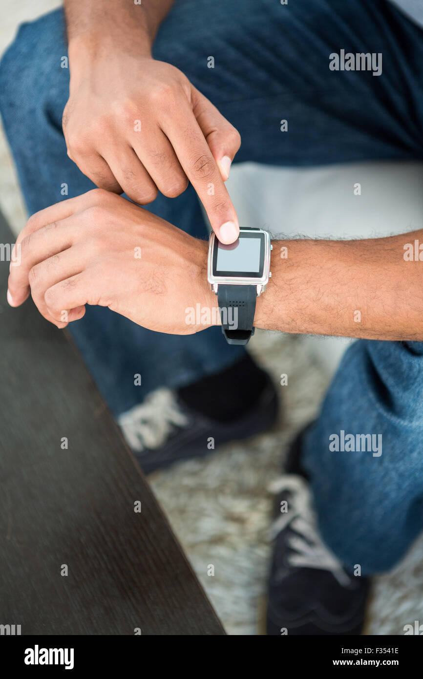 Man touching on smart watch Stock Photo - Alamy