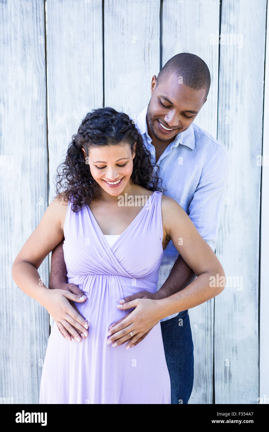Happy pregnant with husband touching belly Stock Photo - Alamy