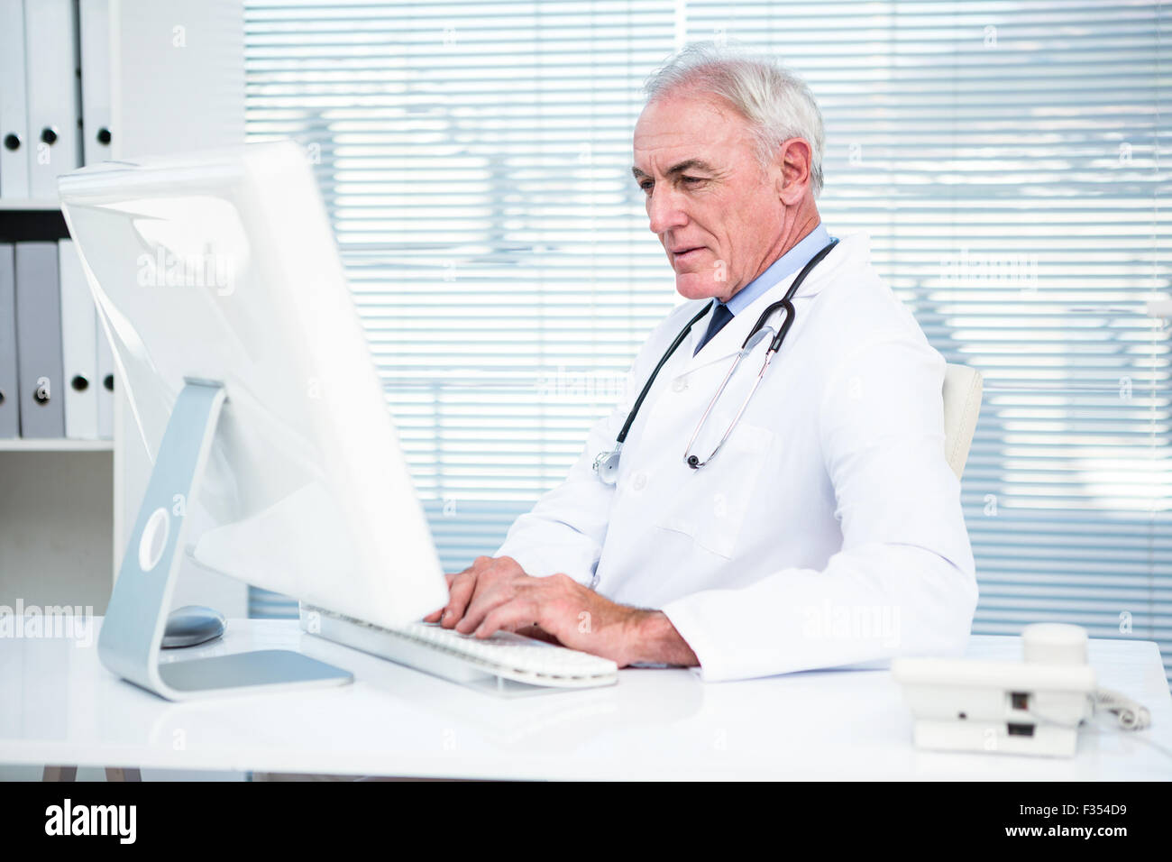 Thoughtful doctor working on computer Stock Photo - Alamy