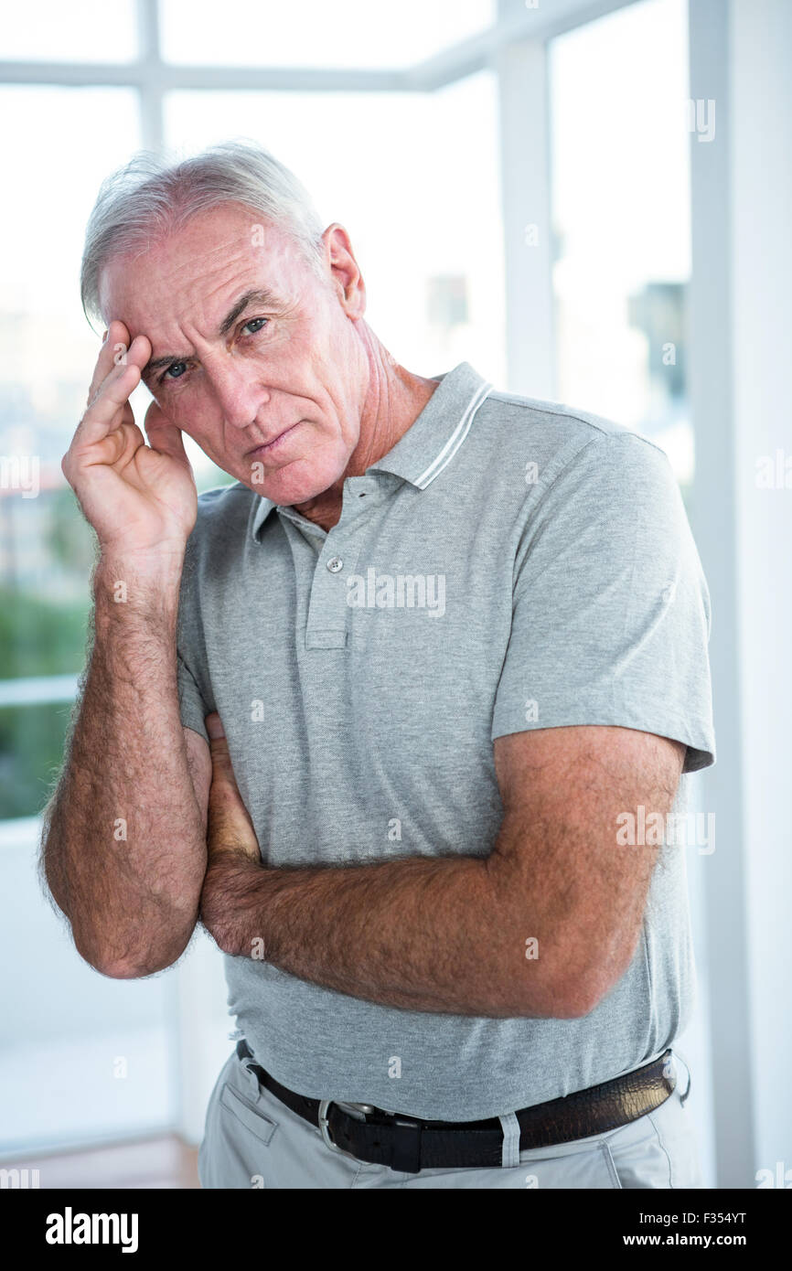Portrait of tensed man touching his head Stock Photo - Alamy