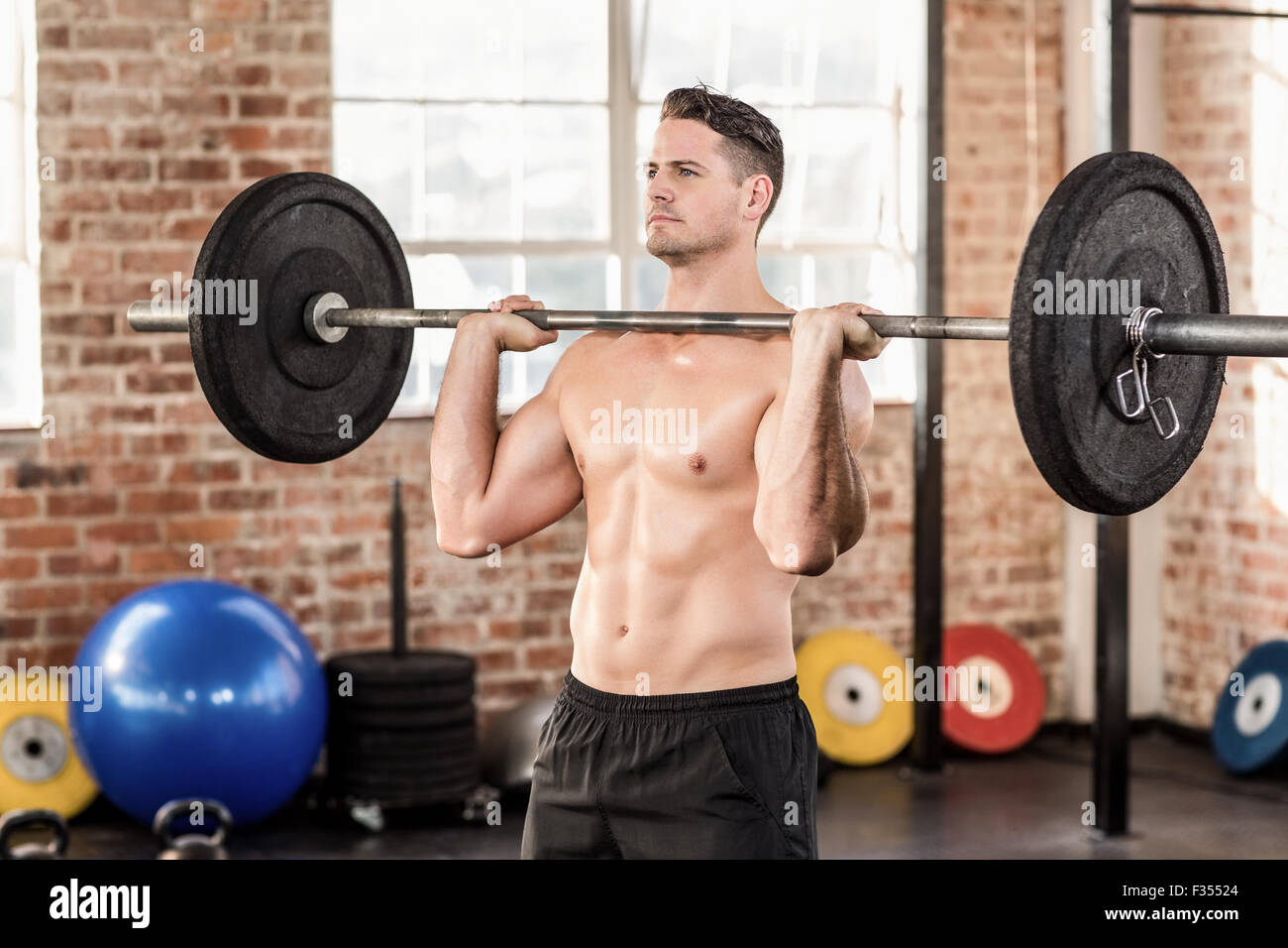 Muscular serious man doing weightlifting Stock Photo - Alamy