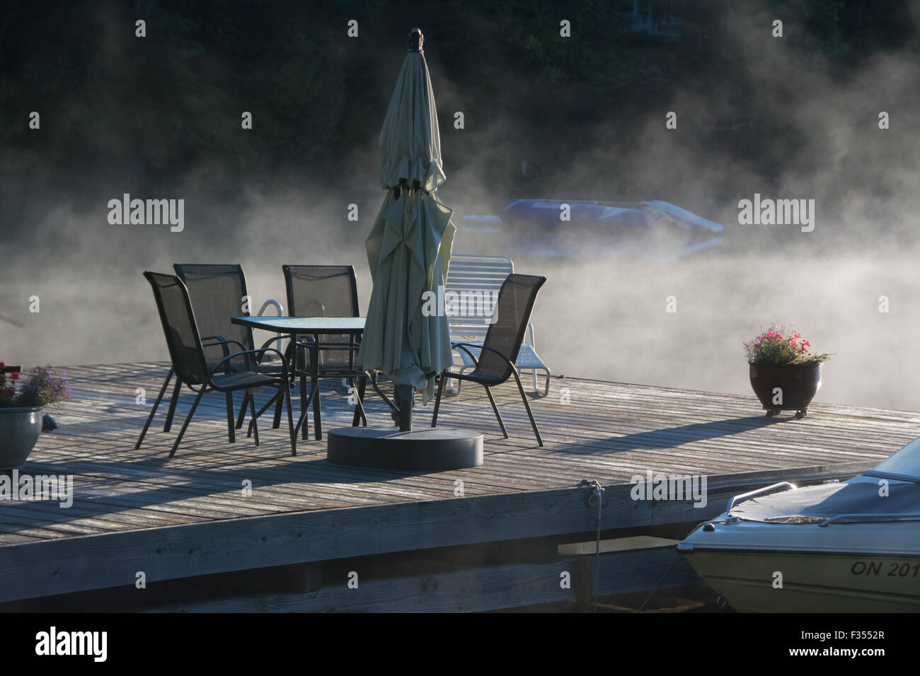 Dock and muskoka chairs on lake muskoka hi-res stock photography and ...
