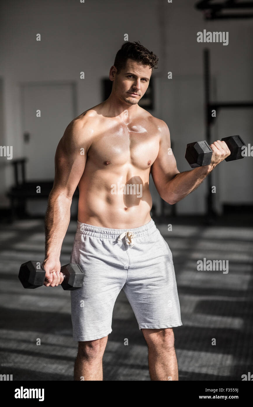 Muscular serious man doing weightlifting Stock Photo - Alamy