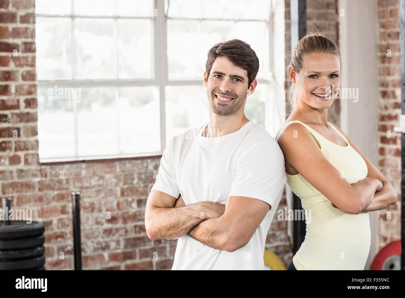 Couple having their arms crossed Stock Photo - Alamy