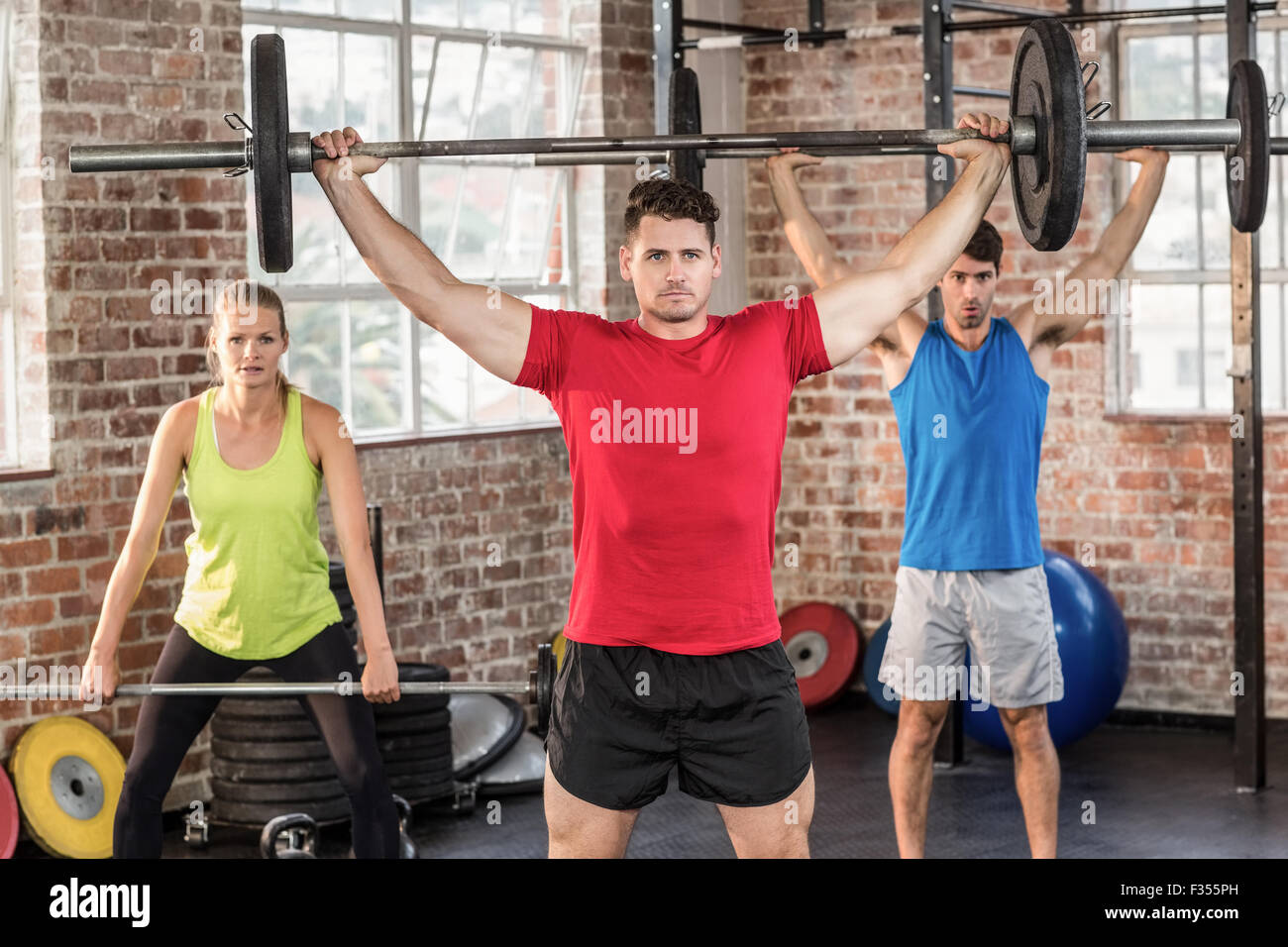 Muscular people lifting dumbbells Stock Photo - Alamy