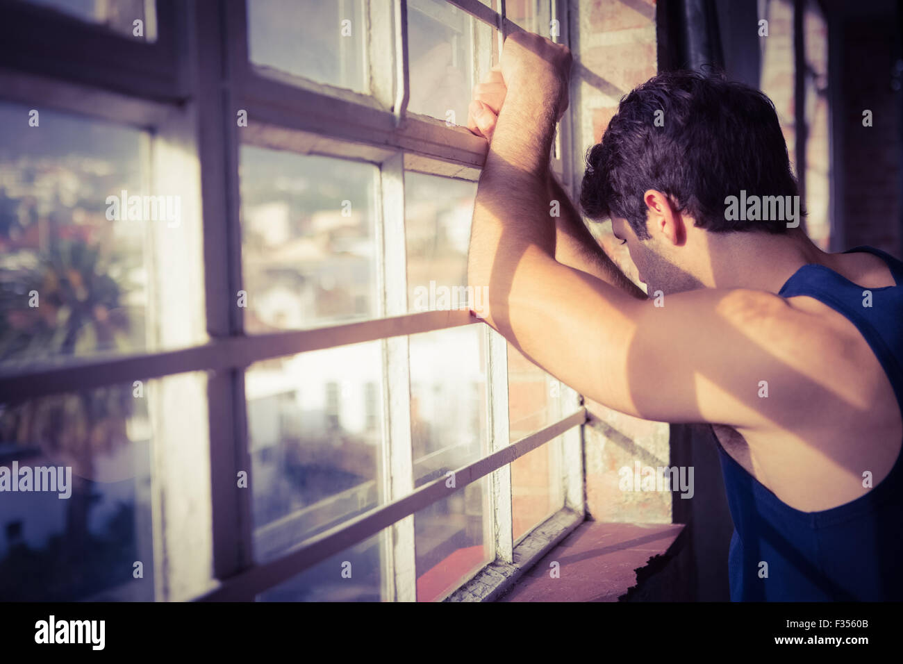 Serious man looking outside from window Stock Photo - Alamy