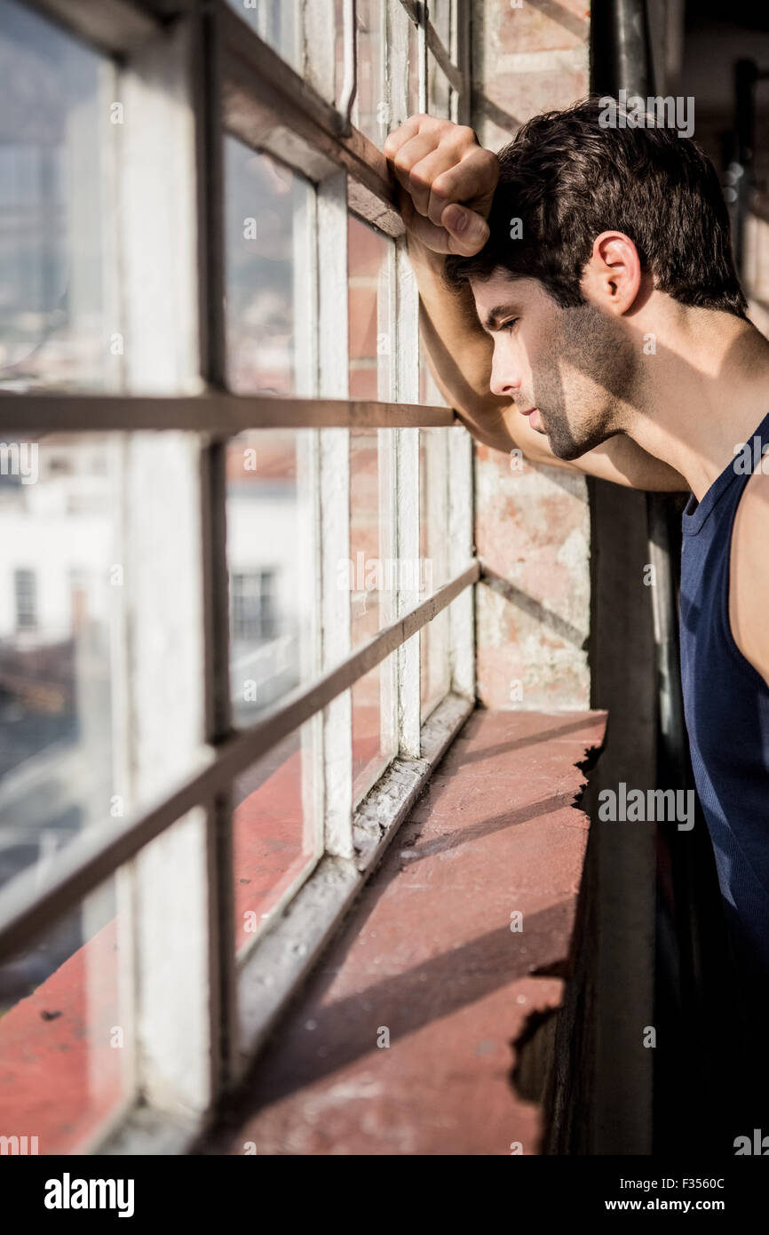 Handsome man looking outside window Stock Photo - Alamy