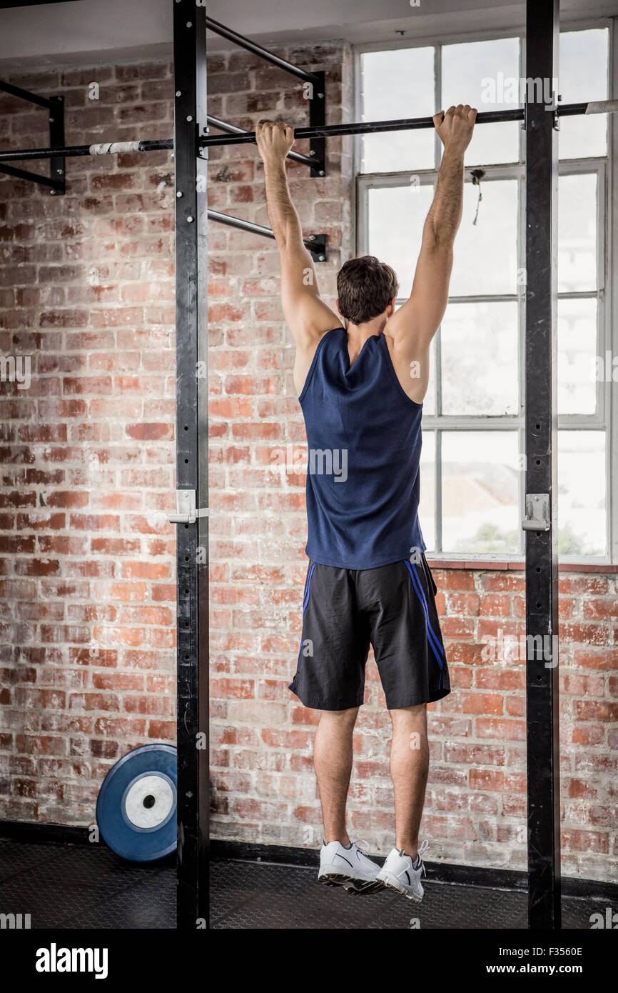 Rear view of man doing pull ups Stock Photo - Alamy