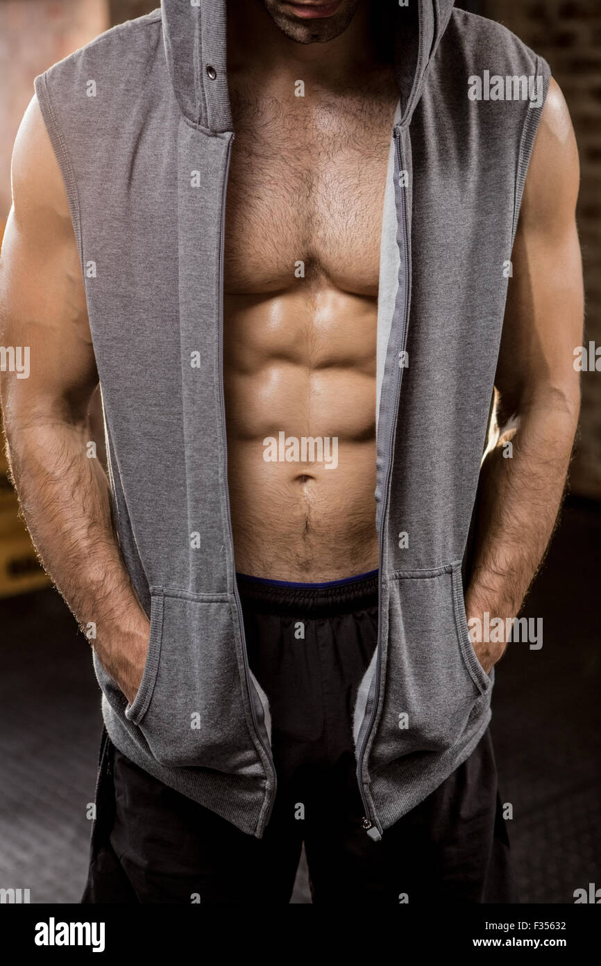Midsection of muscular man wearing hood Stock Photo - Alamy