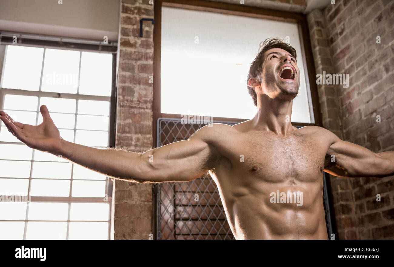 Muscular man with arms stretched Stock Photo - Alamy