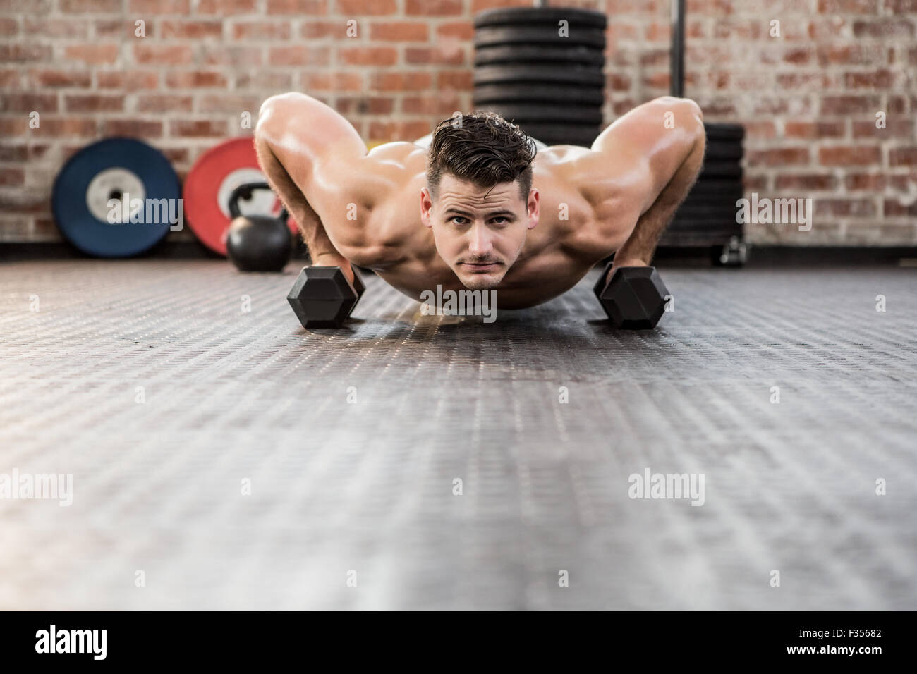 Portrait of man doing dumbbell push ups Stock Photo - Alamy