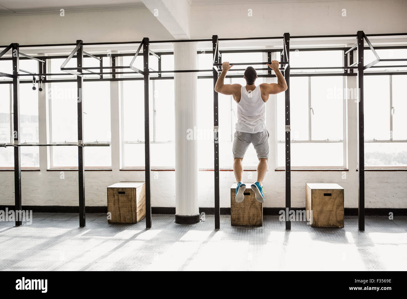 Rear view of muscular man doing pull ups Stock Photo - Alamy