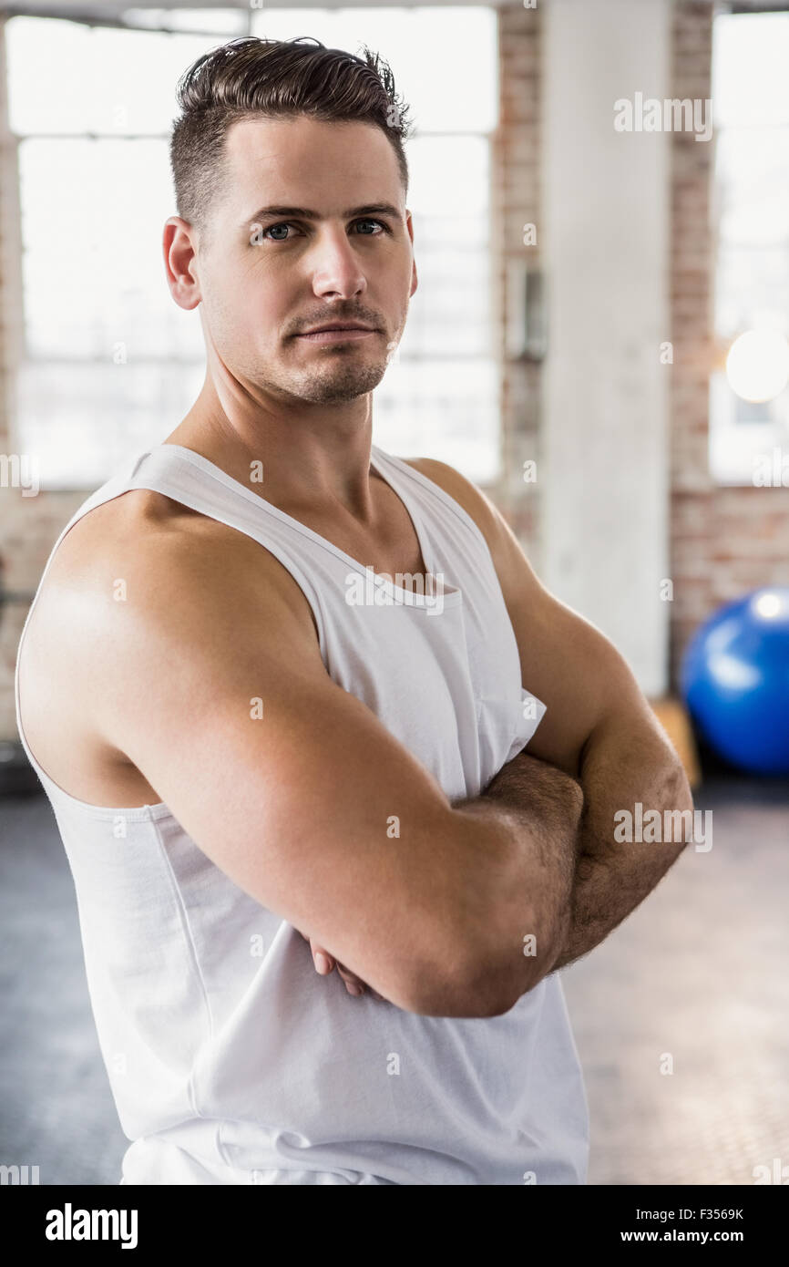 Portrait of a muscular man with arms crossed Stock Photo - Alamy
