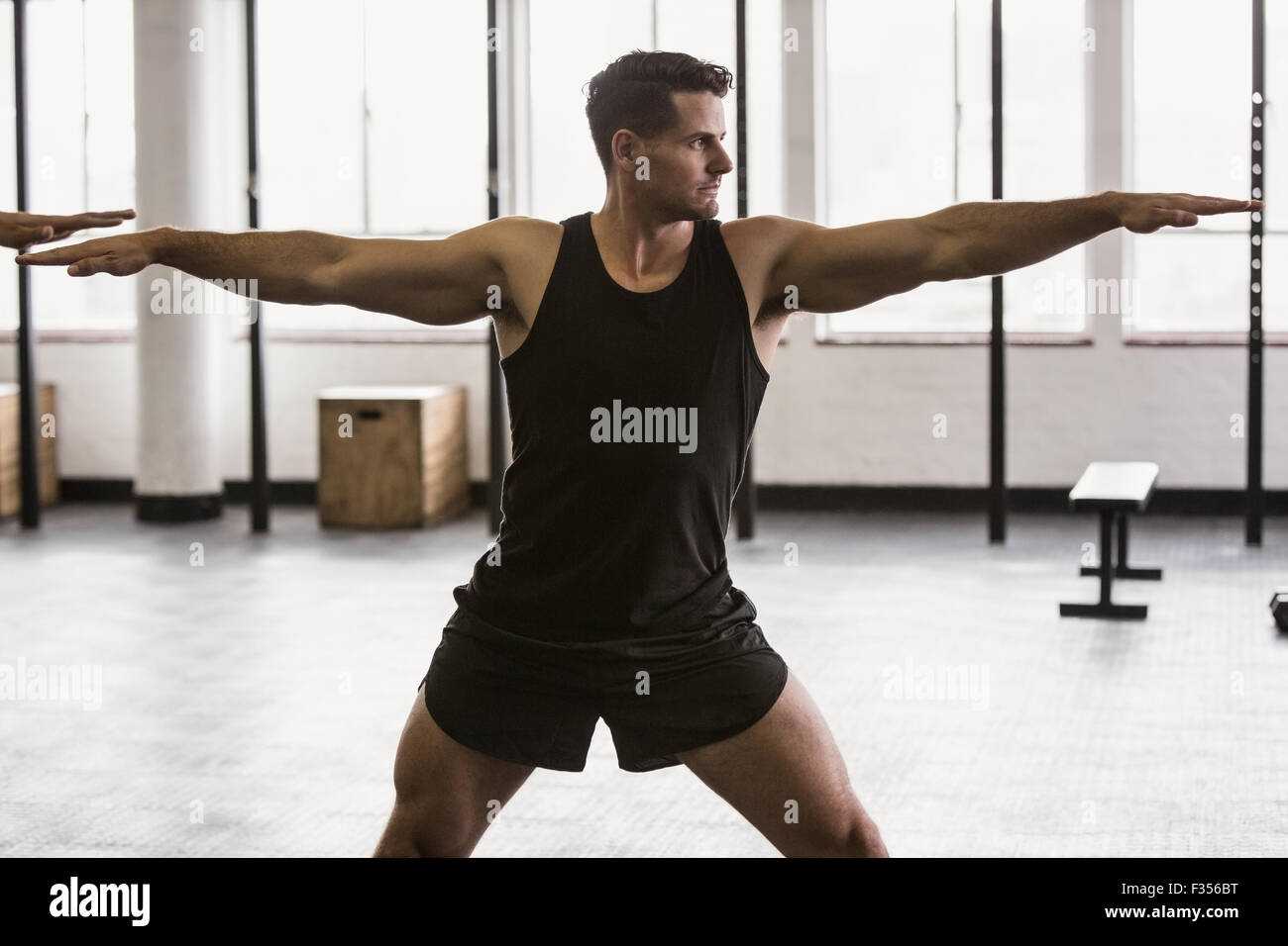 Focused man stretching arm Stock Photo - Alamy