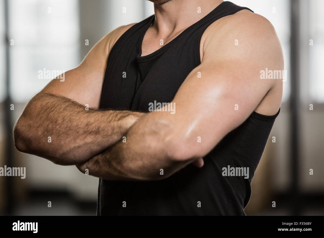 Midsection of man with arms crossed Stock Photo - Alamy