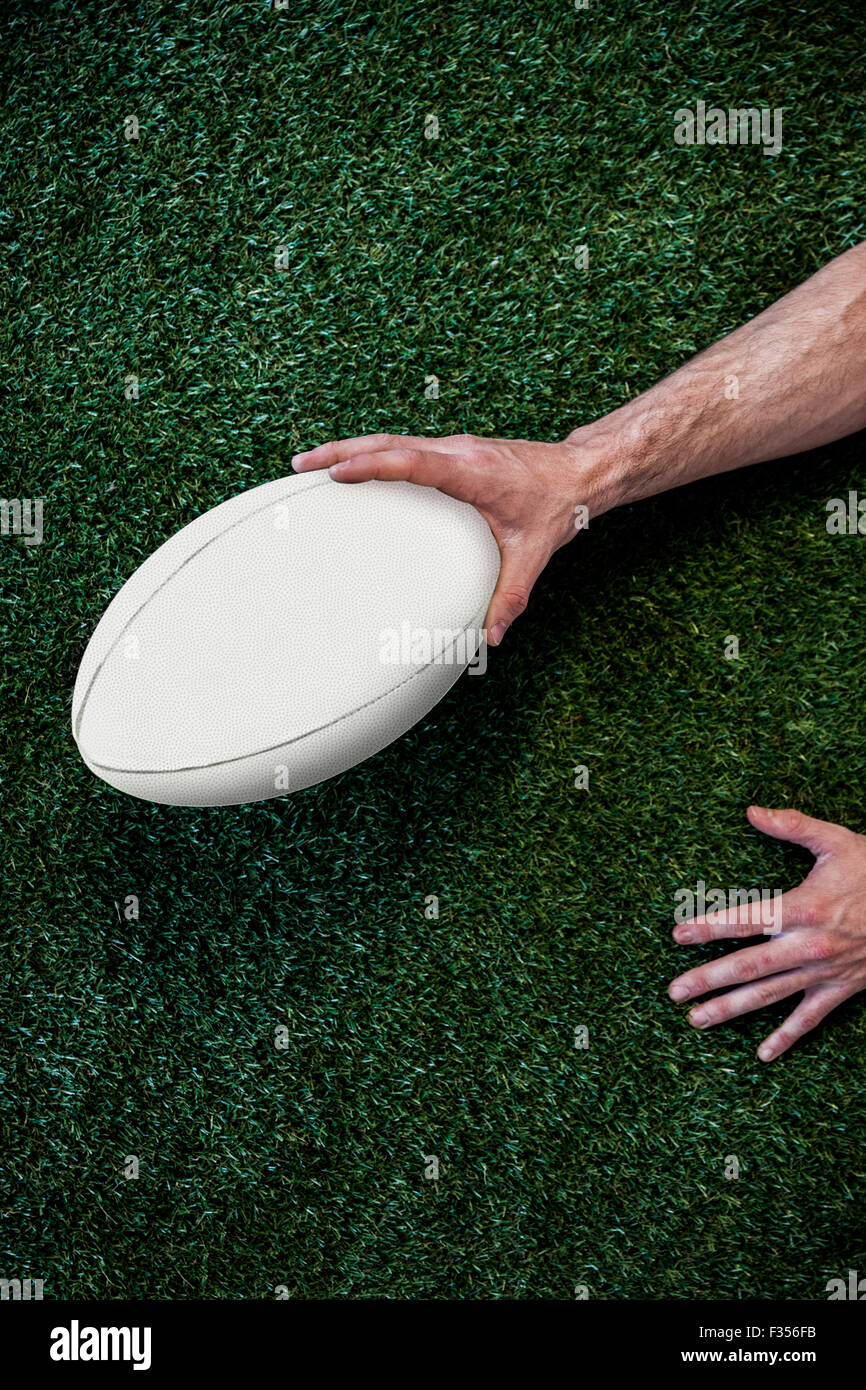 Cropped image of a man holding rugby ball Stock Photo - Alamy