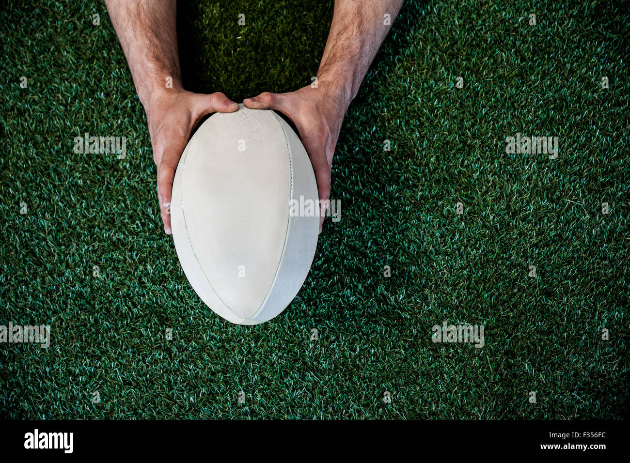 Man holding rugby ball Stock Photo - Alamy