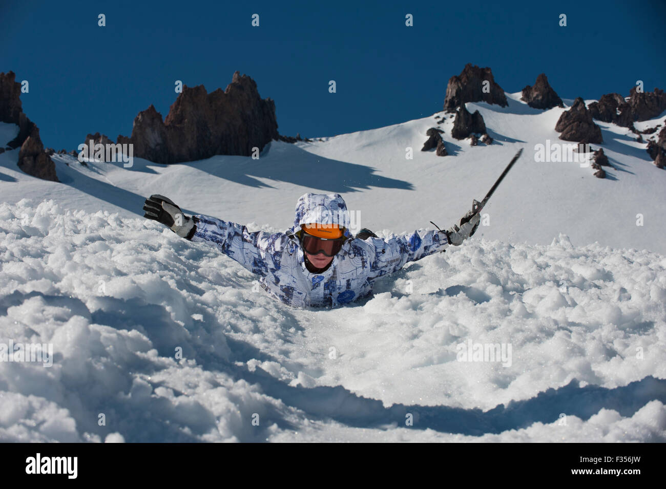 A climber practices a self arrest technique with an ice ax on Mount ...