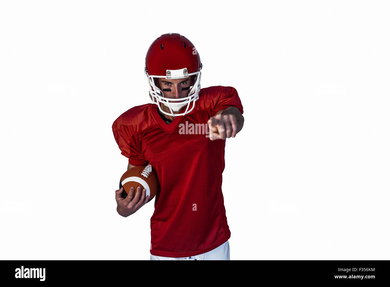 Portrait of rugby player pointing while holding ball Stock Photo - Alamy
