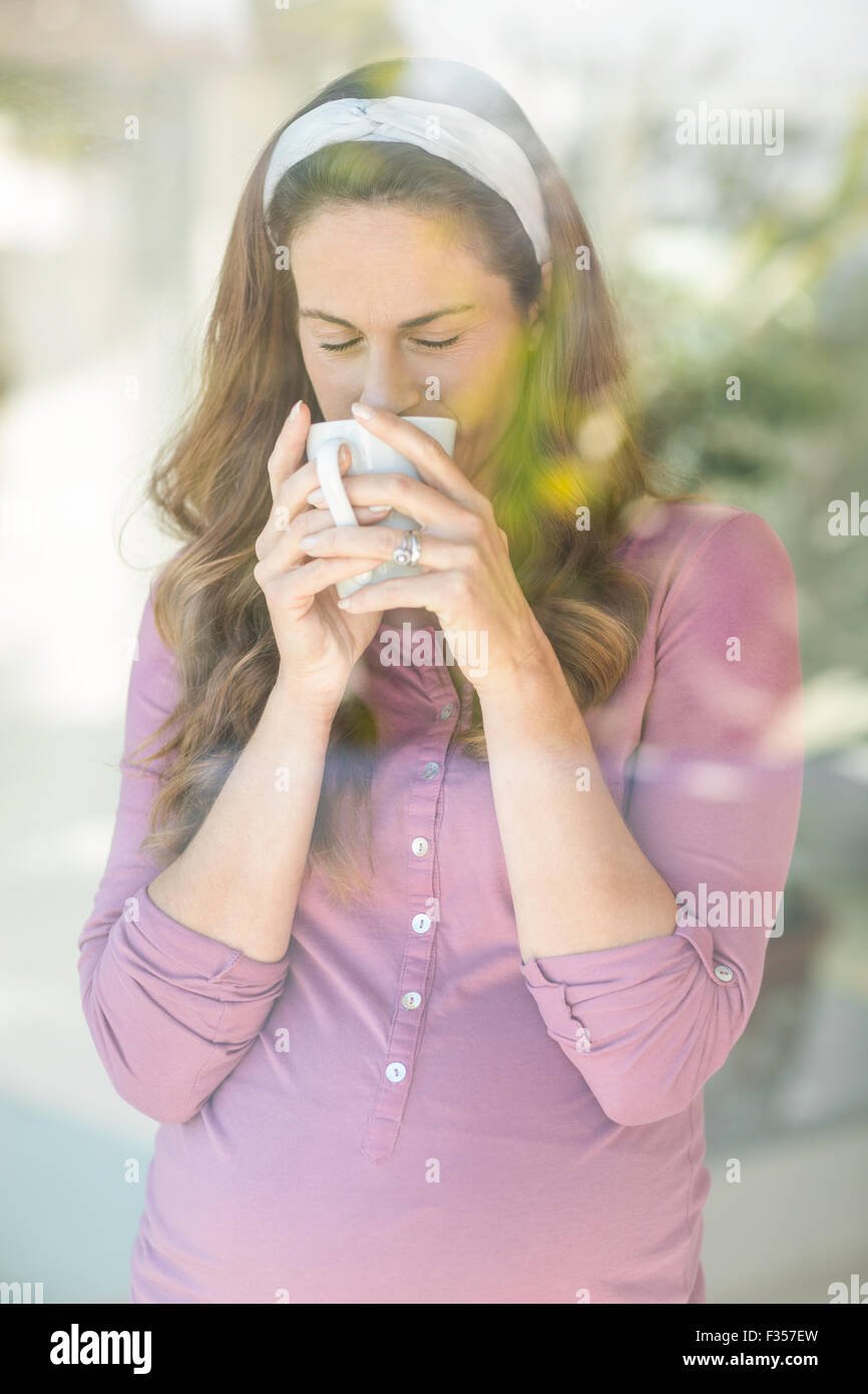 Woman sipping coffee from cup Stock Photo - Alamy
