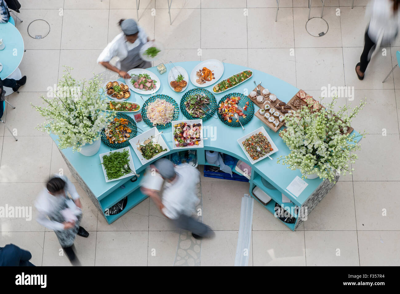 Chefs and waiters race around a food counter Stock Photo - Alamy