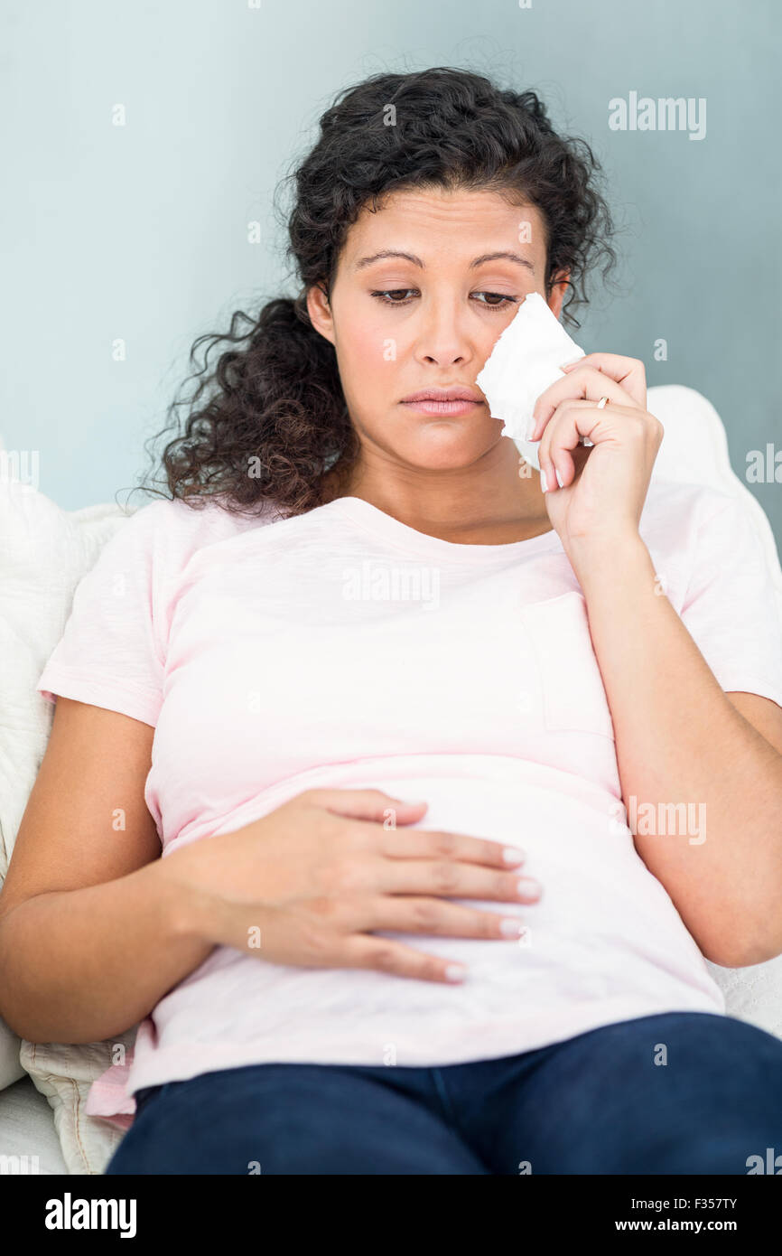 Unhappy woman with tissue crying Stock Photo - Alamy