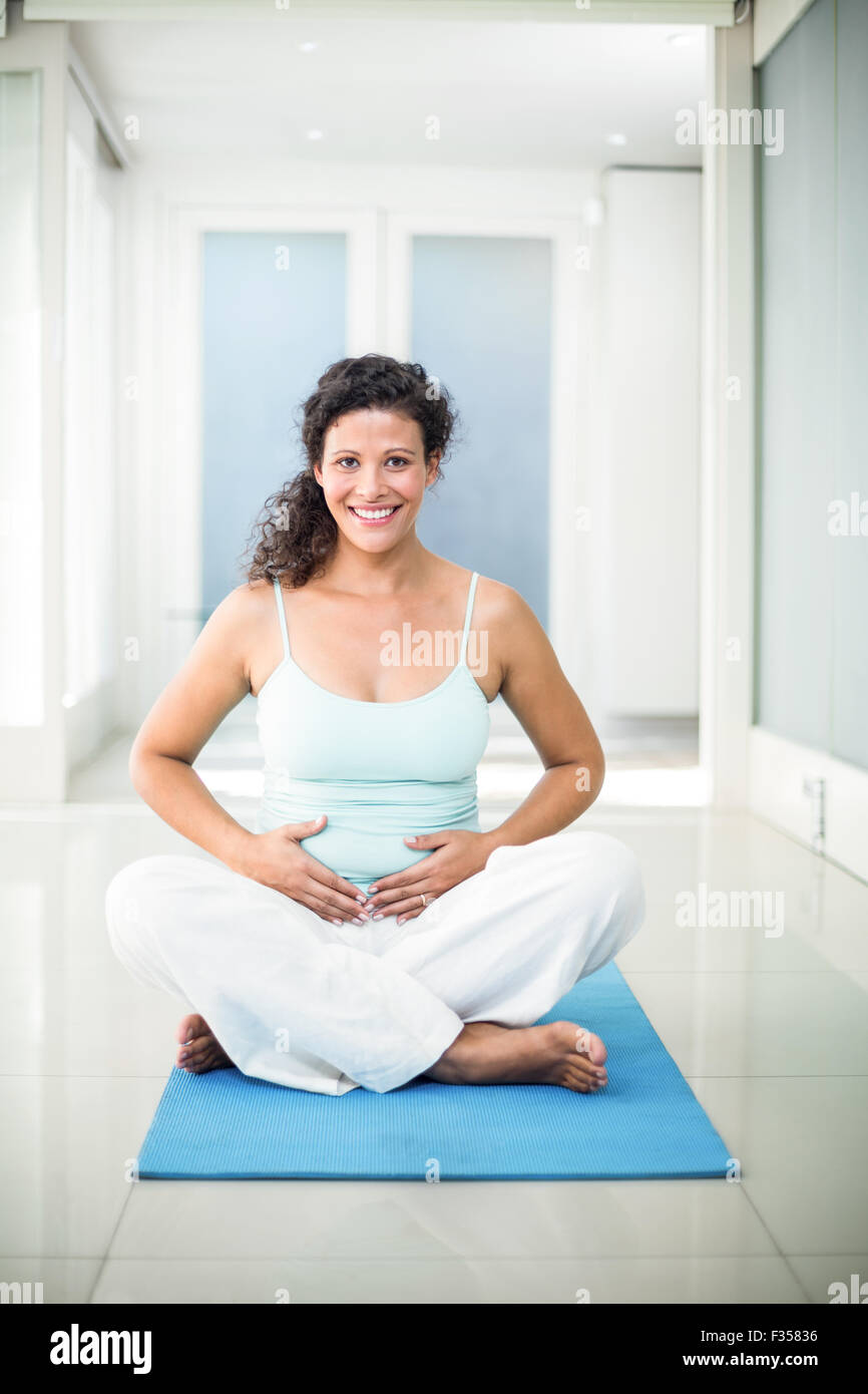 Portrait of smiling pregnant woman touching her belly Stock Photo - Alamy