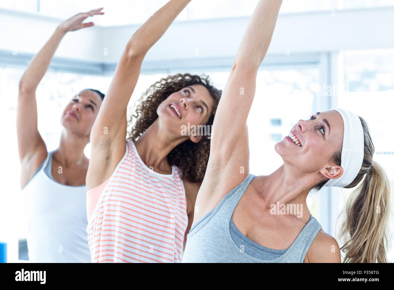 Sporty woman with arm raised Stock Photo - Alamy